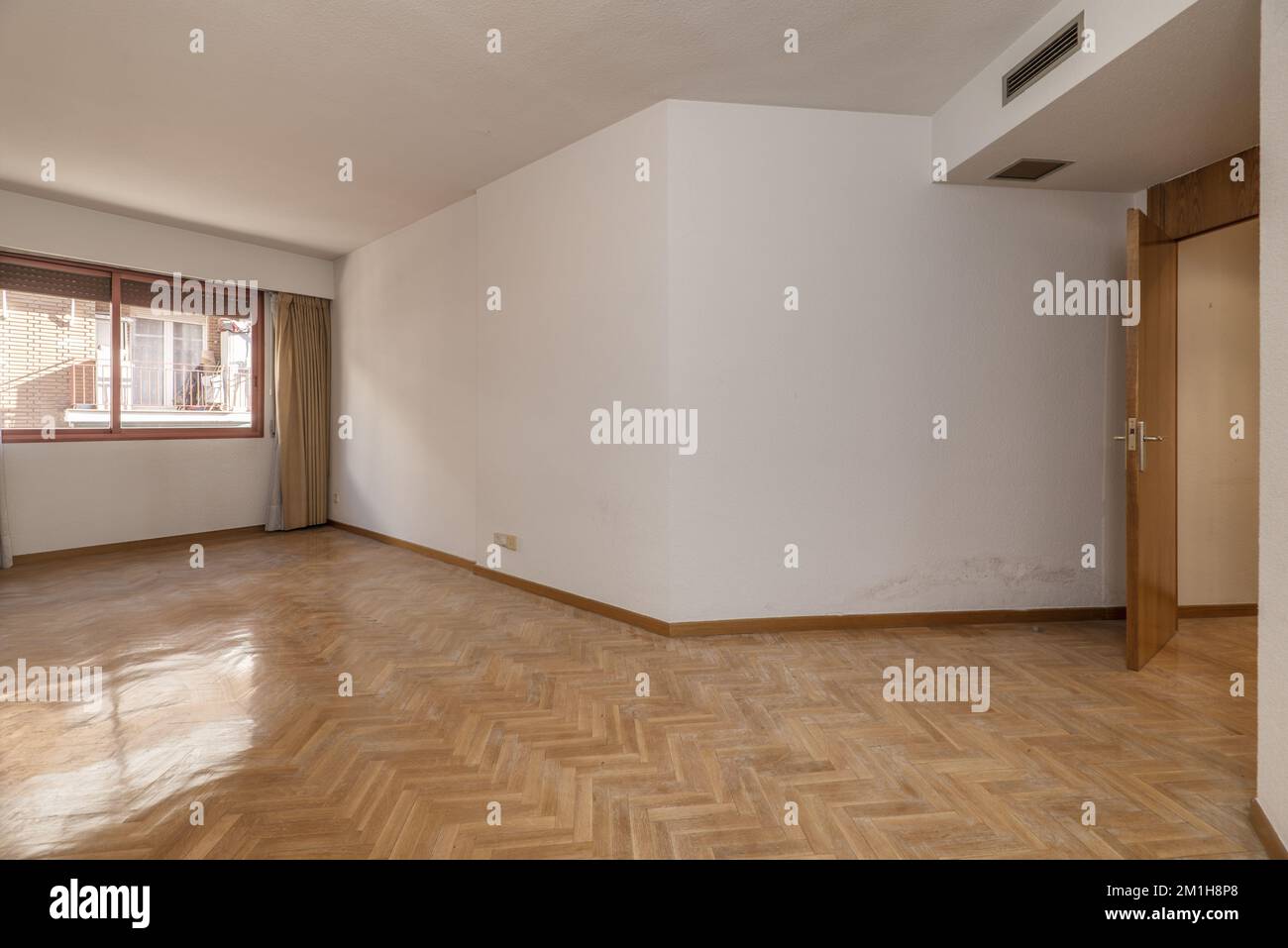 Empty room with white painted walls, French oak parquet wooden floor ...