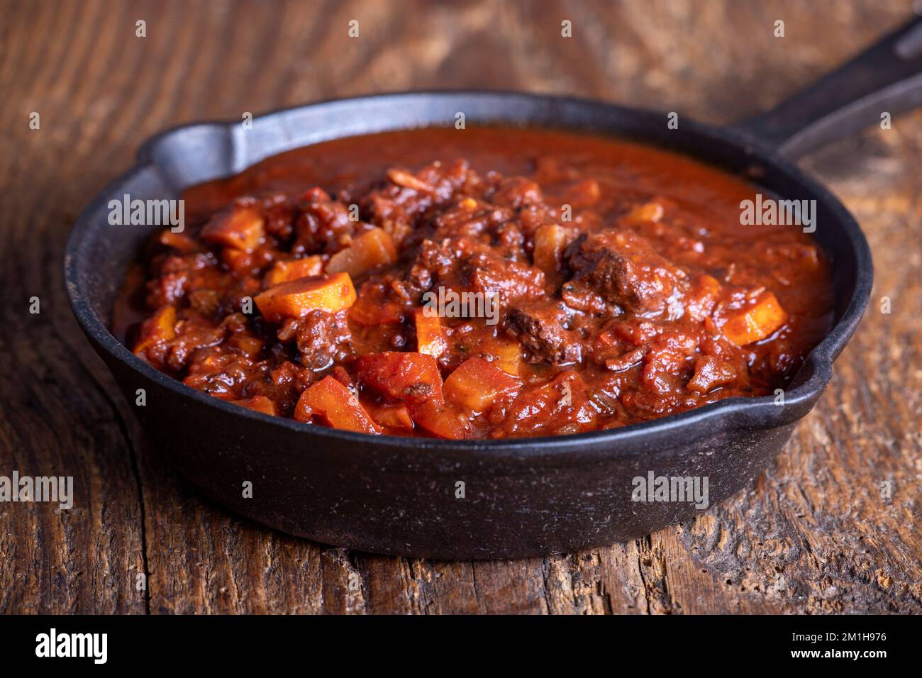 hungarian goulash on dark wood Stock Photo - Alamy