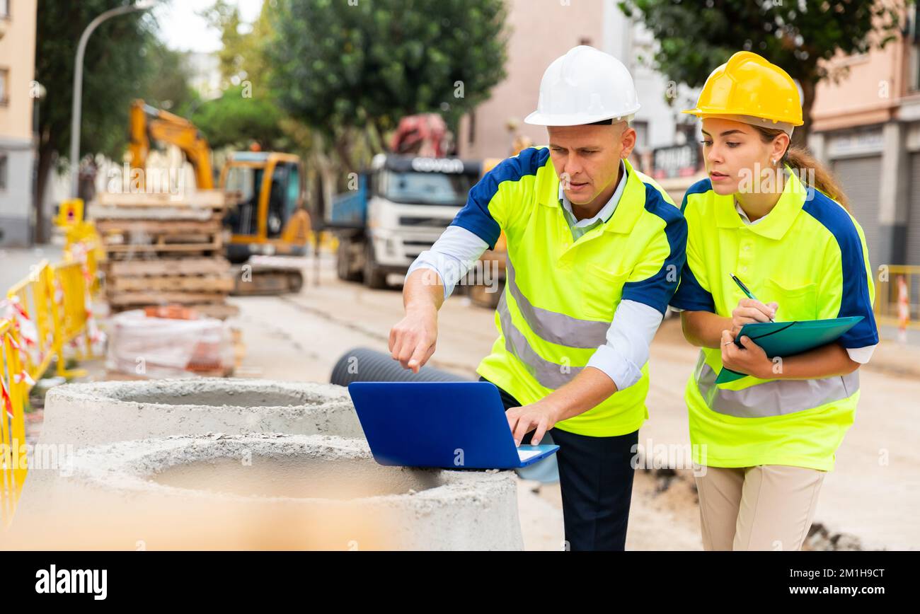Two builders planning their work in construction plant Stock Photo - Alamy