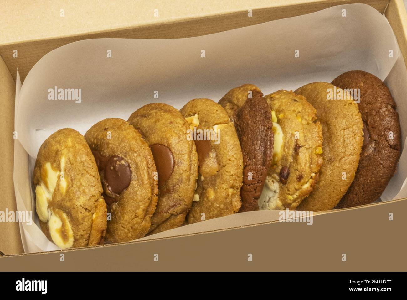 A home delivery cardboard box filled with two flavored baked chocolate ...