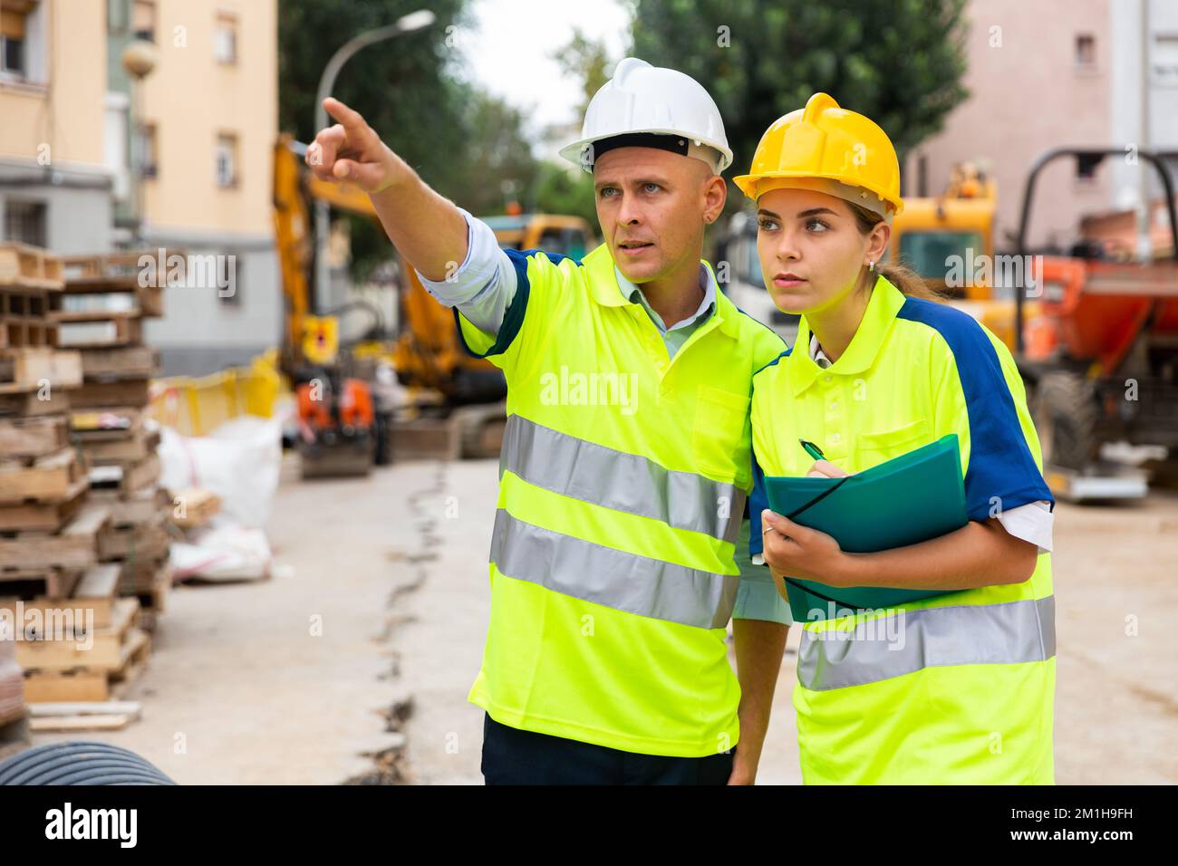 Civil engineers checking work process in construction site Stock Photo ...
