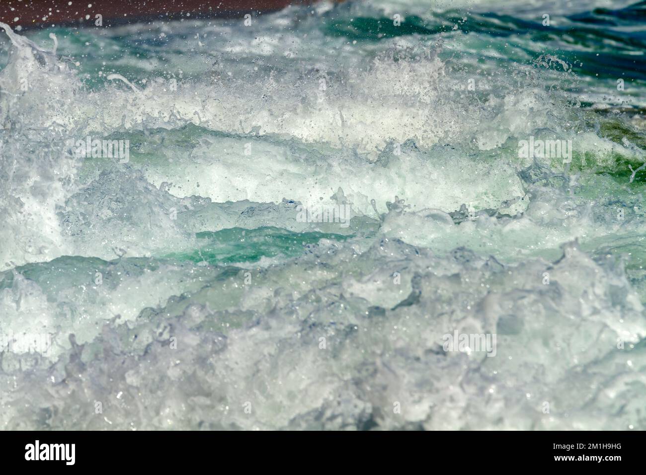 Ocean waves close up as they roll onto a tropical beach in Hawaii, USA ...