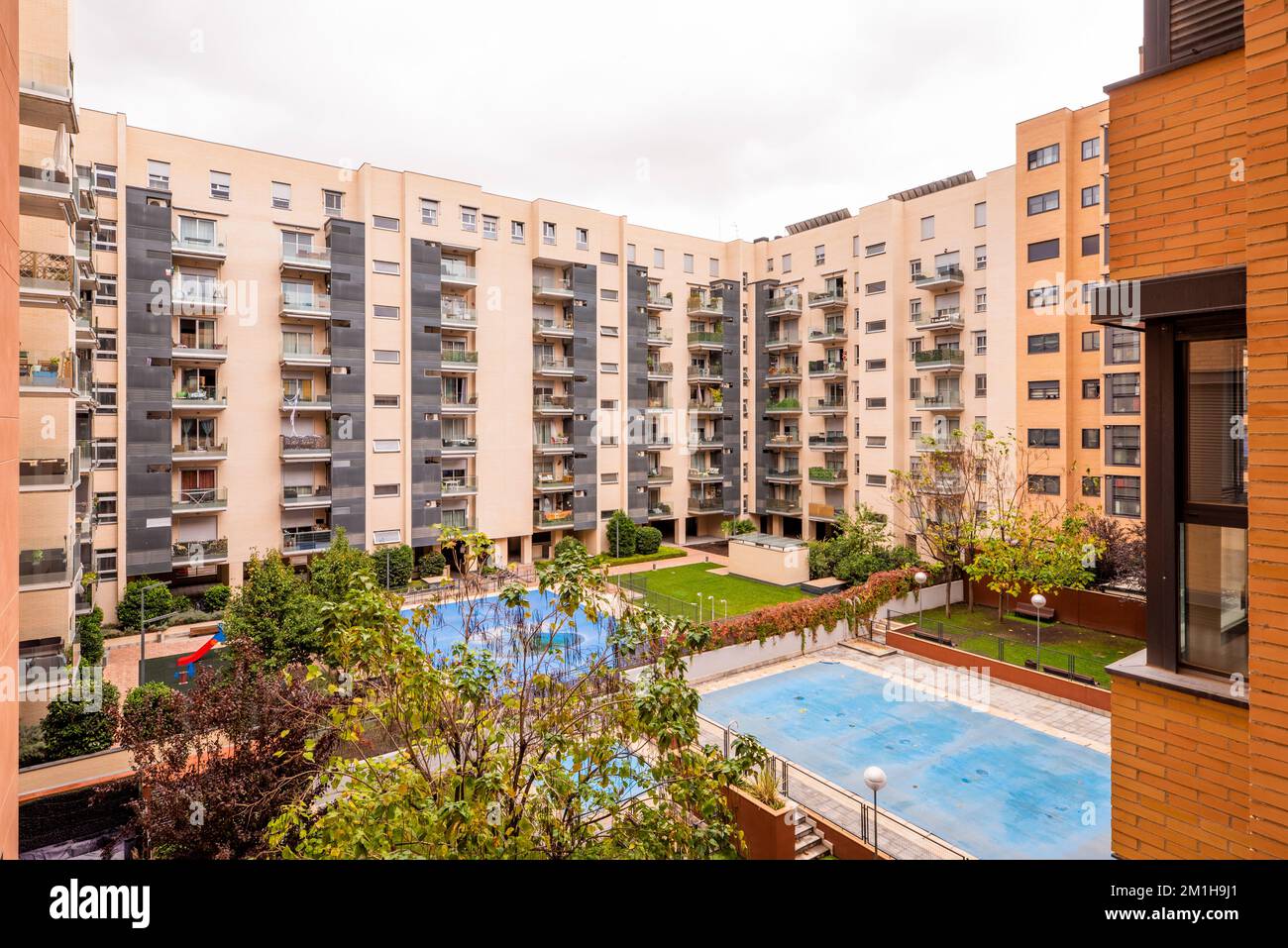 Interior facades of a block patio of residential buildings with gardens ...