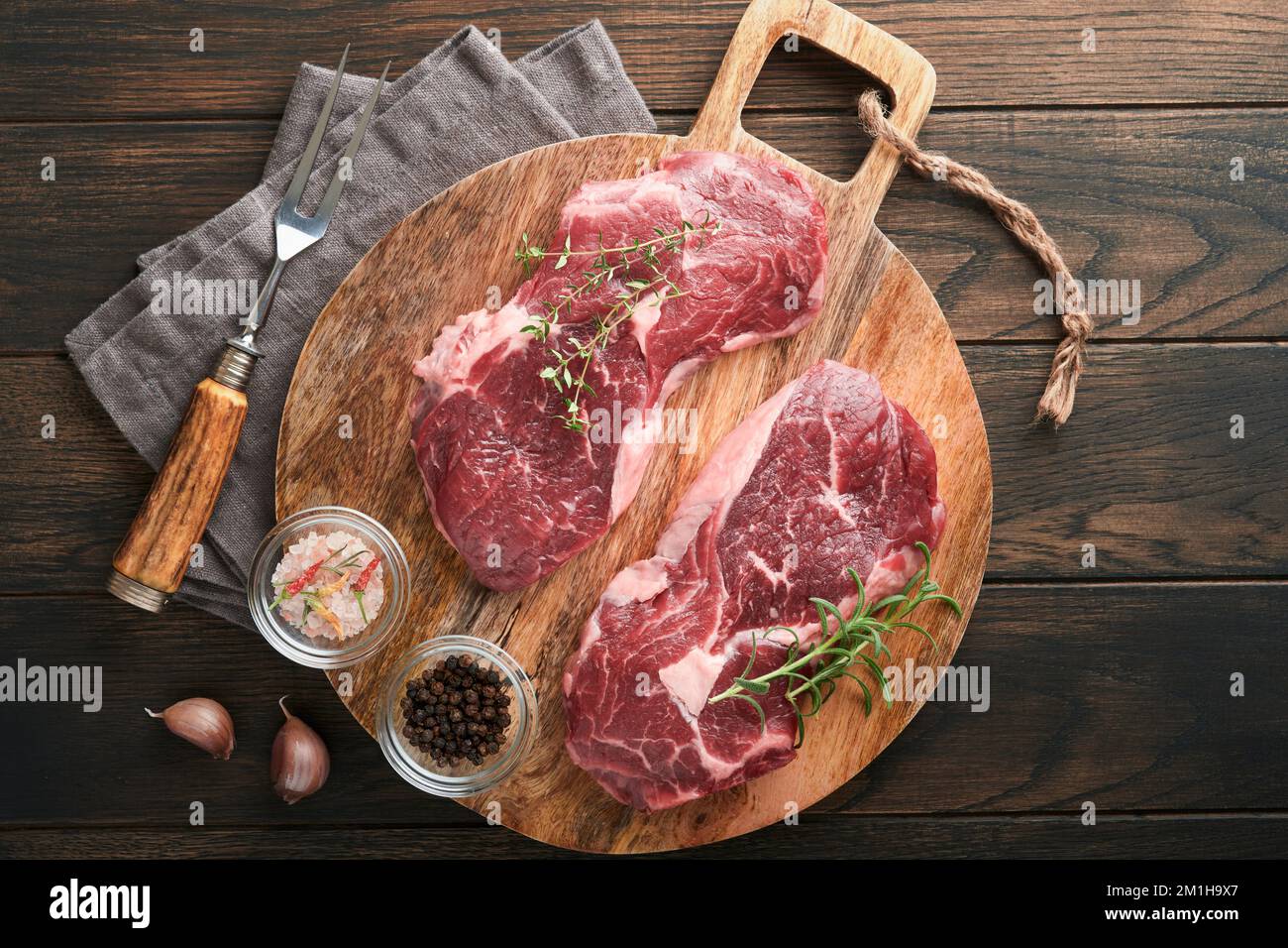 Raw beef steak. Marbled raw fresh Ribeye steak with rosemary, salt and ...