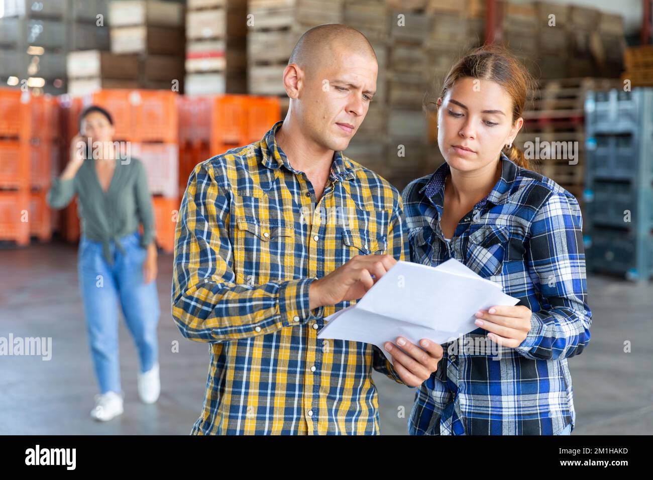 Man and young woman talking about documentation Stock Photo - Alamy