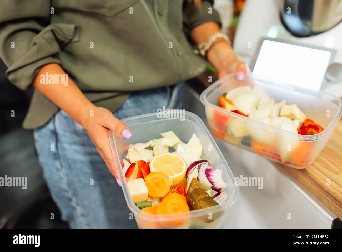 Unrecognizable cropped woman hands hold two container box with fresh ...