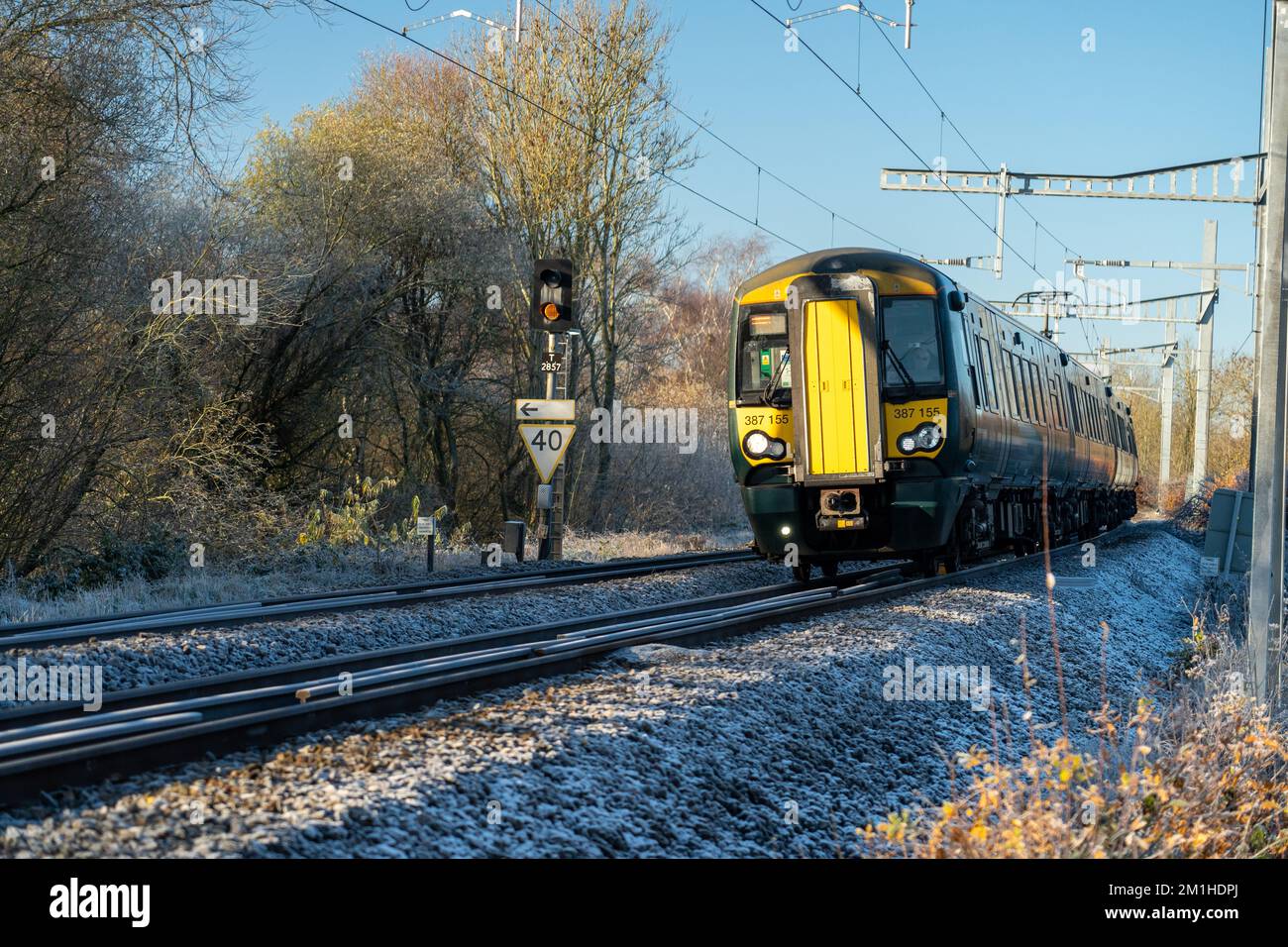 An electric GWR train on a frozen frosty track travelling to London ...
