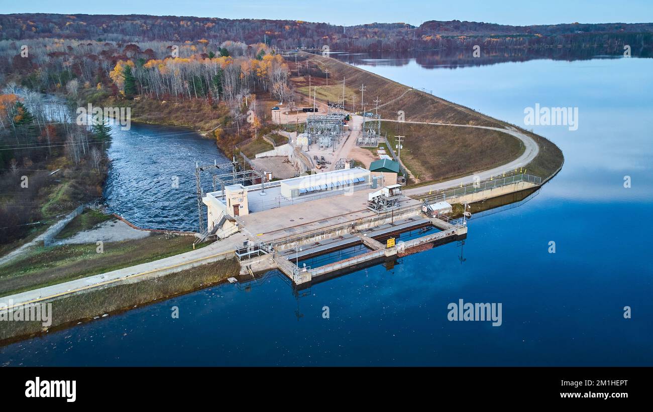 Michigan dam on smooth lake leading to river in late fall forest Stock ...