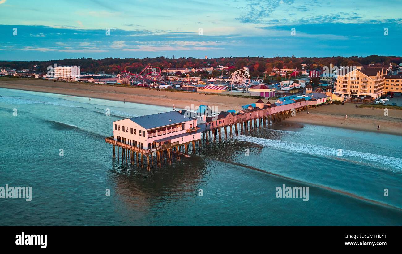 Serene morning light over old pier covered in shop from drone over ...