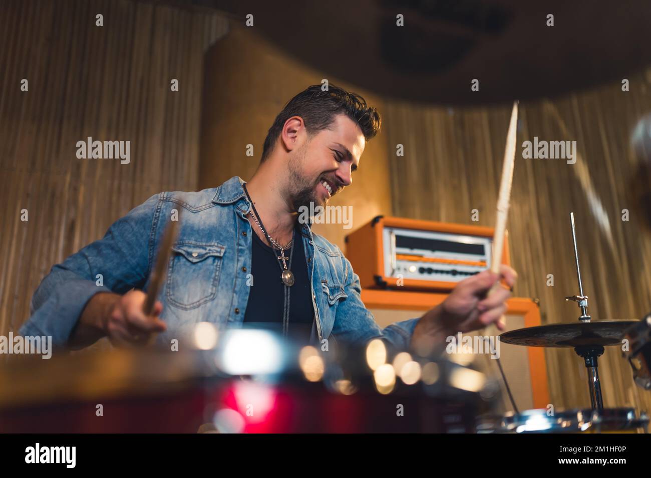 Excited drummer in recording studio. Caucasian middle aged stylish male ...