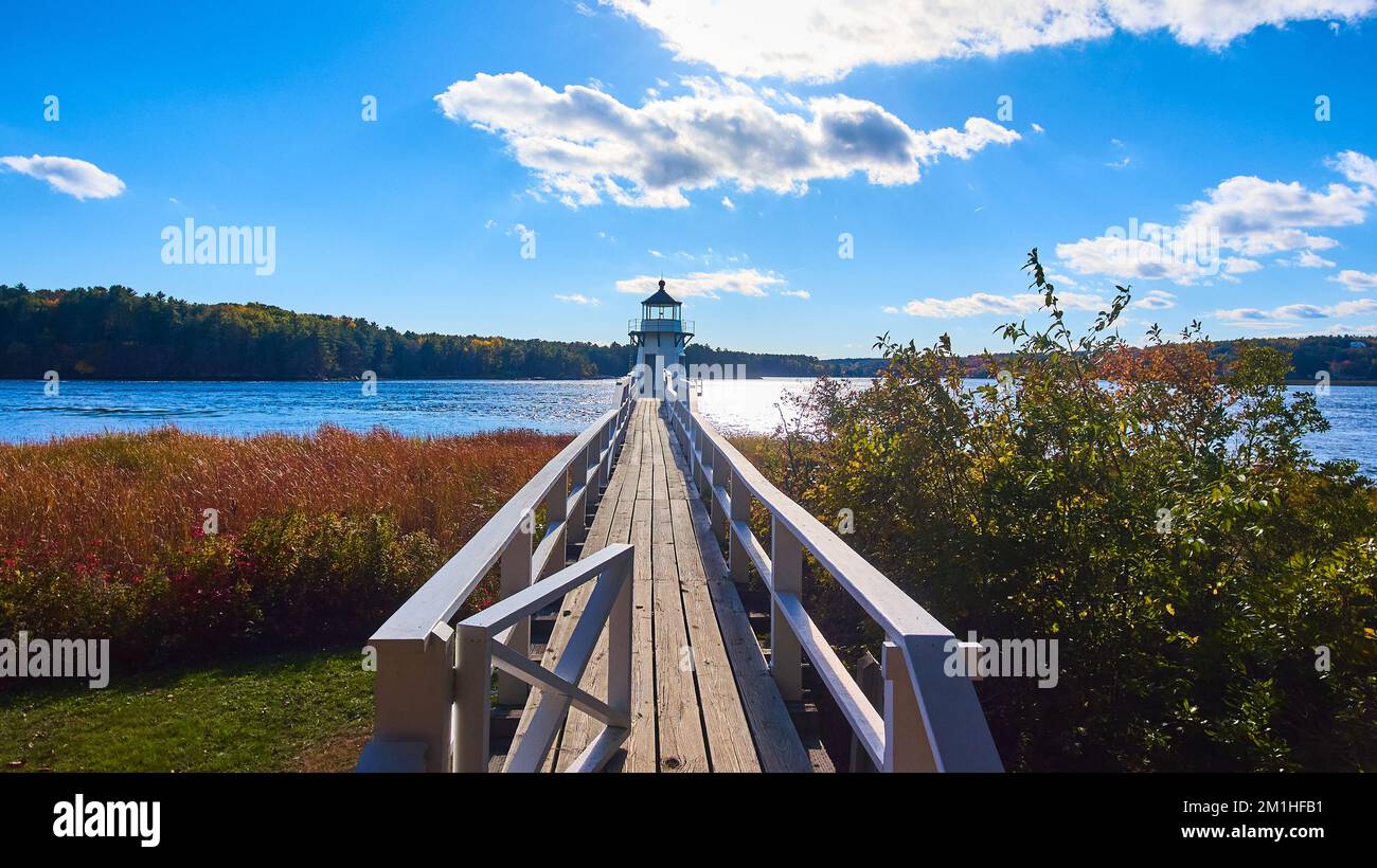 Small boardwalk pedestrian walkway bridge with gate leading towards ...