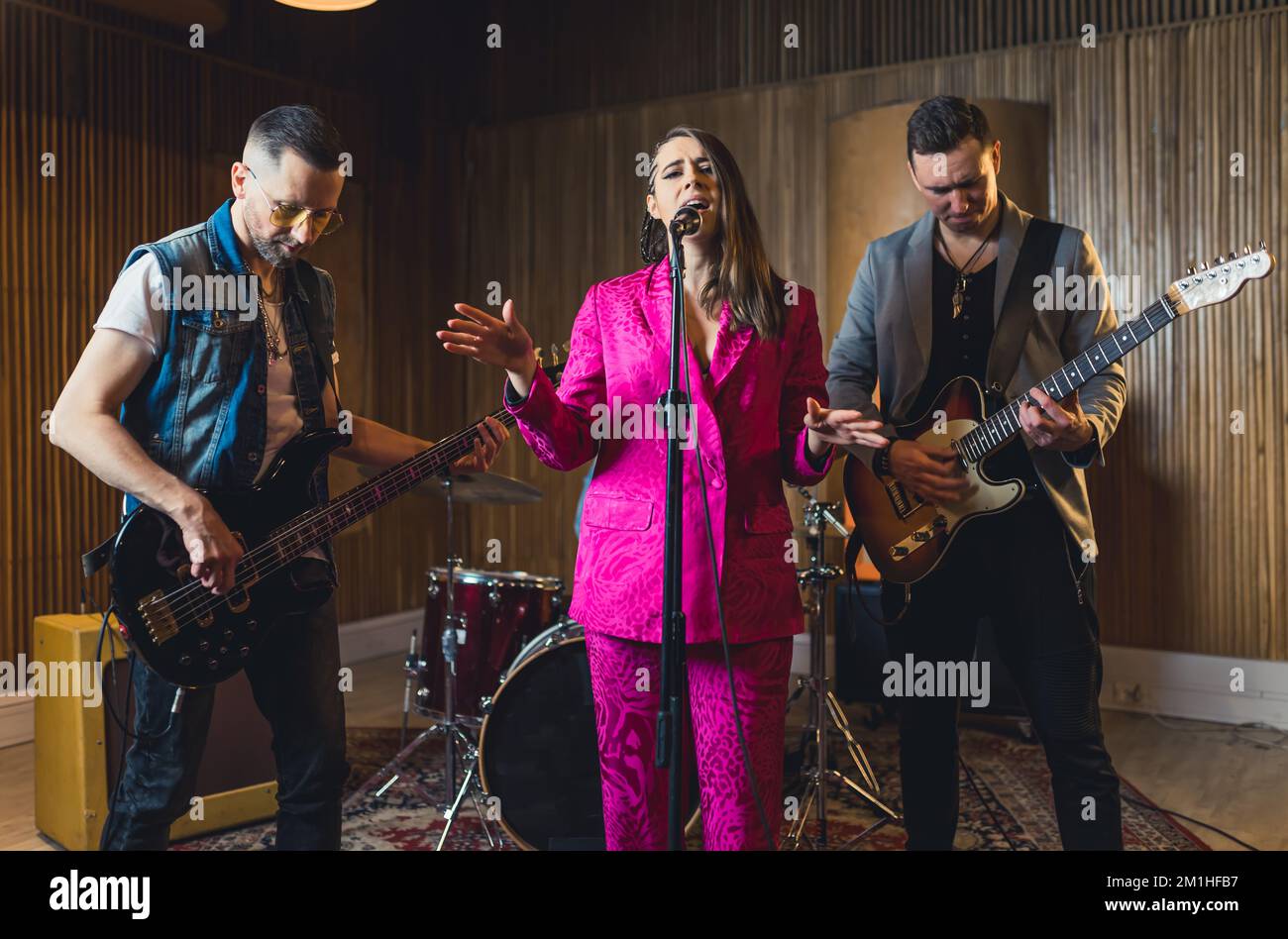 medium-full shot of a band while rehearsal, musical studio band concept. High quality photo ...