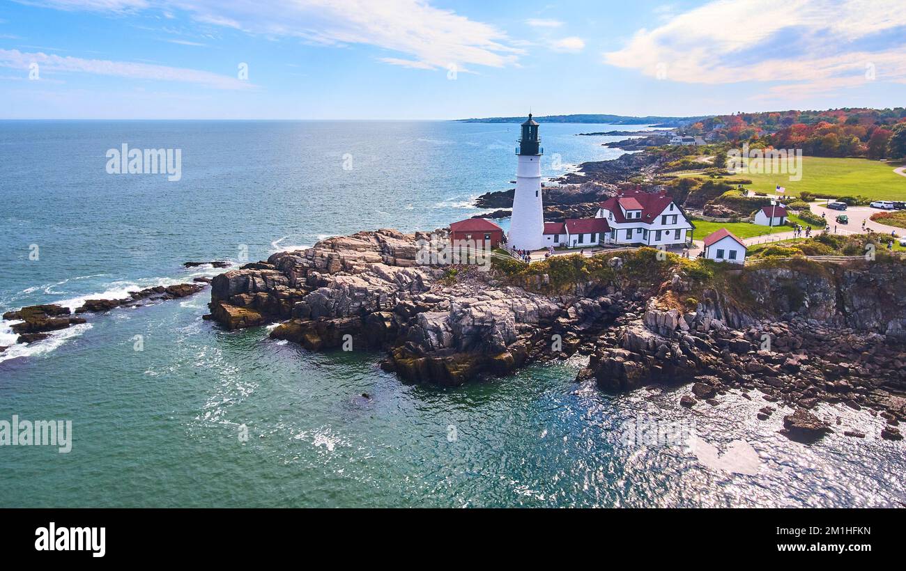 Stunning lighthouse on rocky cliffs in Maine from aerial view Stock ...