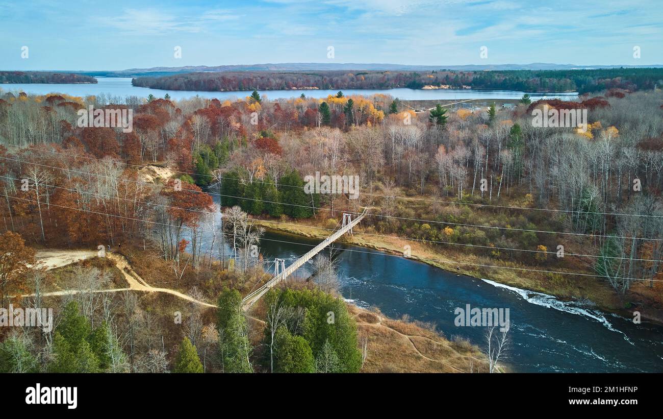 Suspension bridge over river in late fall from above Stock Photo - Alamy
