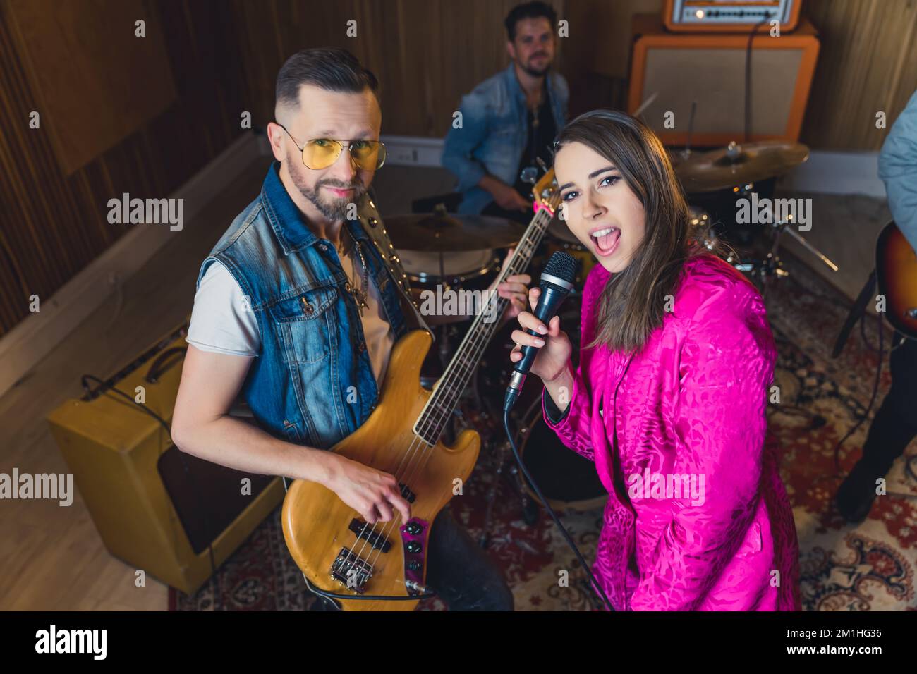 High angle shot of two stylish band members looking at camera. Excited ...