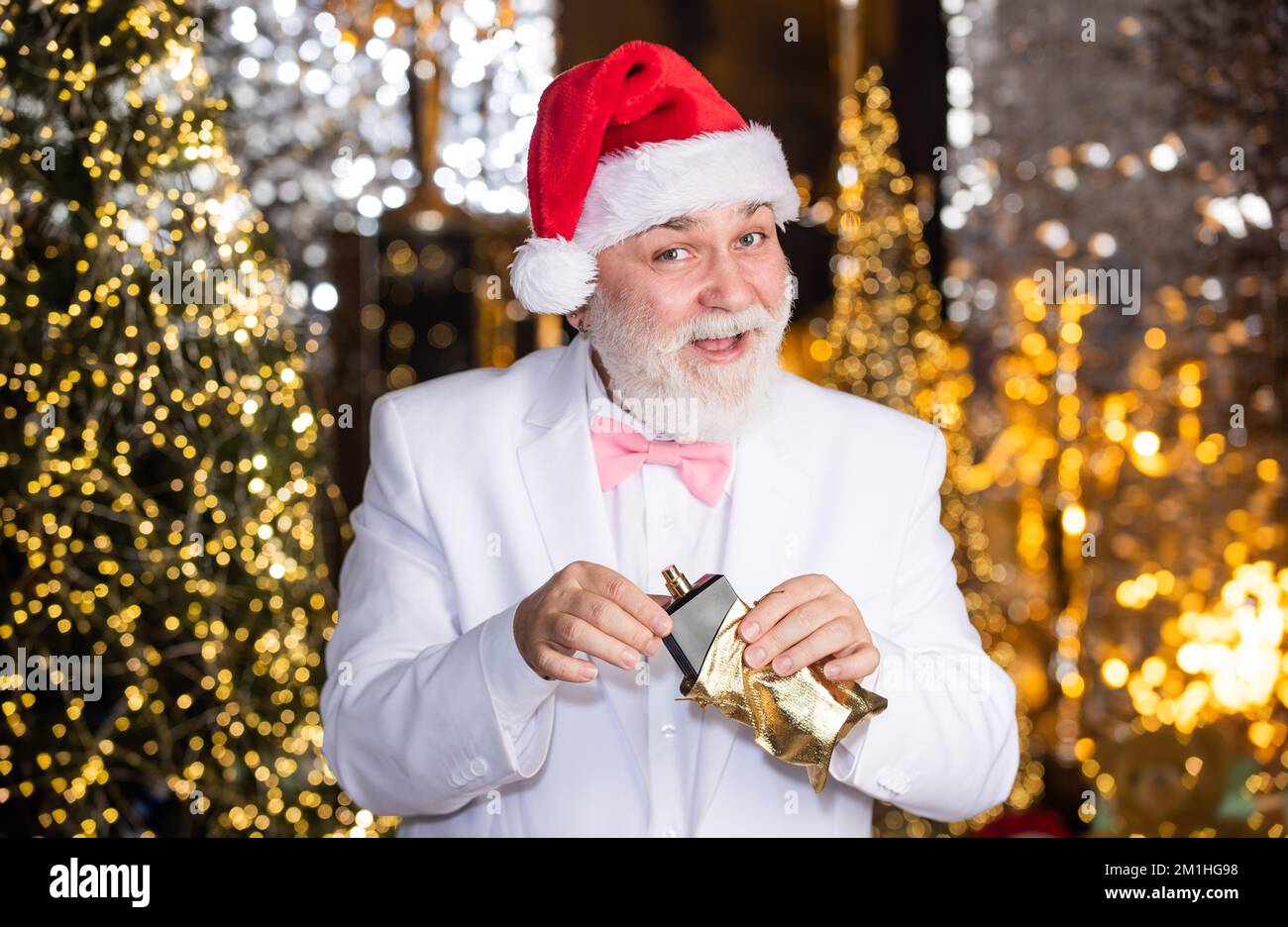 Just look at that. happy man with perfume illuminated background. santa ...