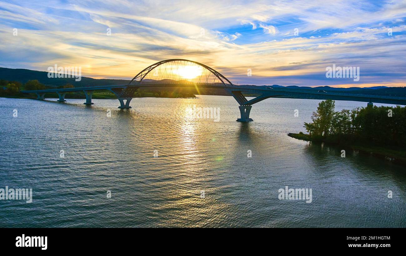 Aerial of bridge with sun in arch during sunset connecting New York to ...