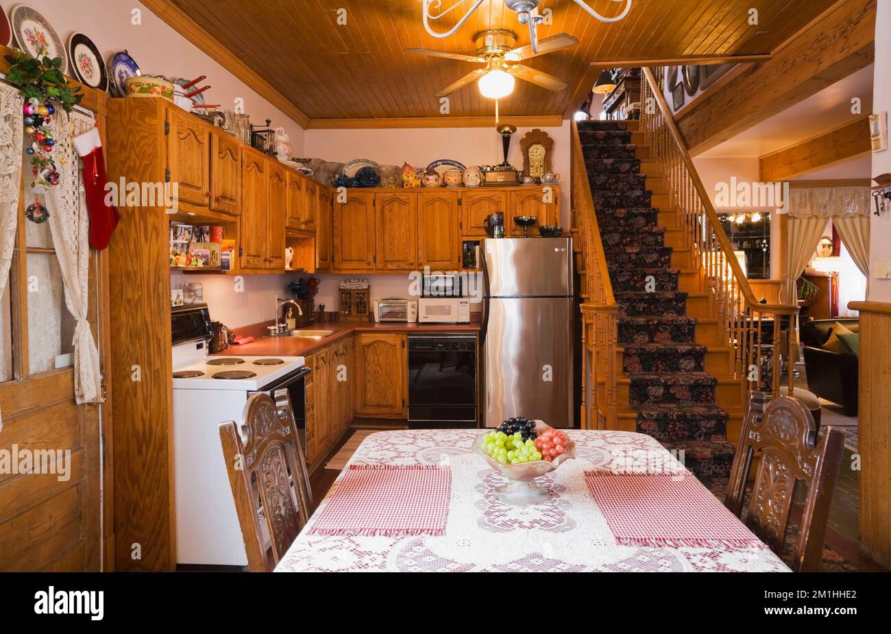 Table with fruit bowl and antique high back chairs in kitchen inside ...