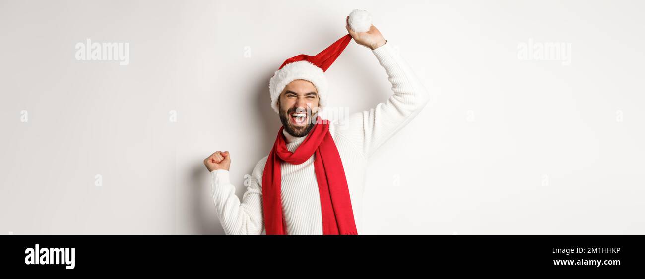 Winter holidays and New Year party concept. Happy man celebrating ...
