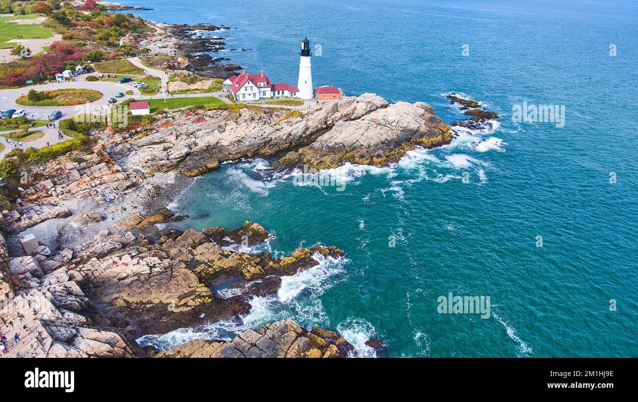 Wide panorama aerial over Portland Head lighthouse with rocky coast ...