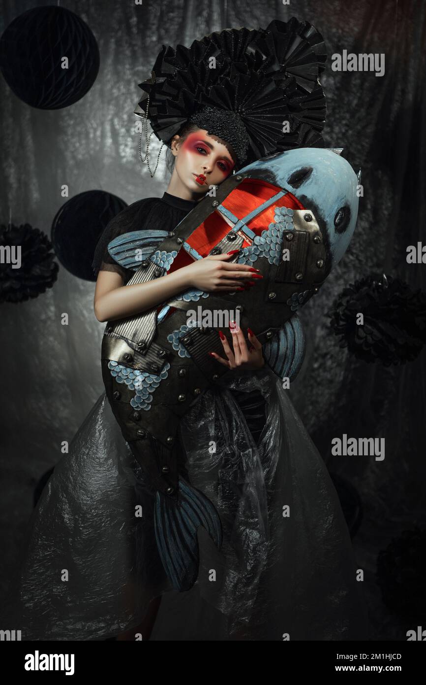 A beautiful girl, a modern geisha in a black outfit on a dark ...