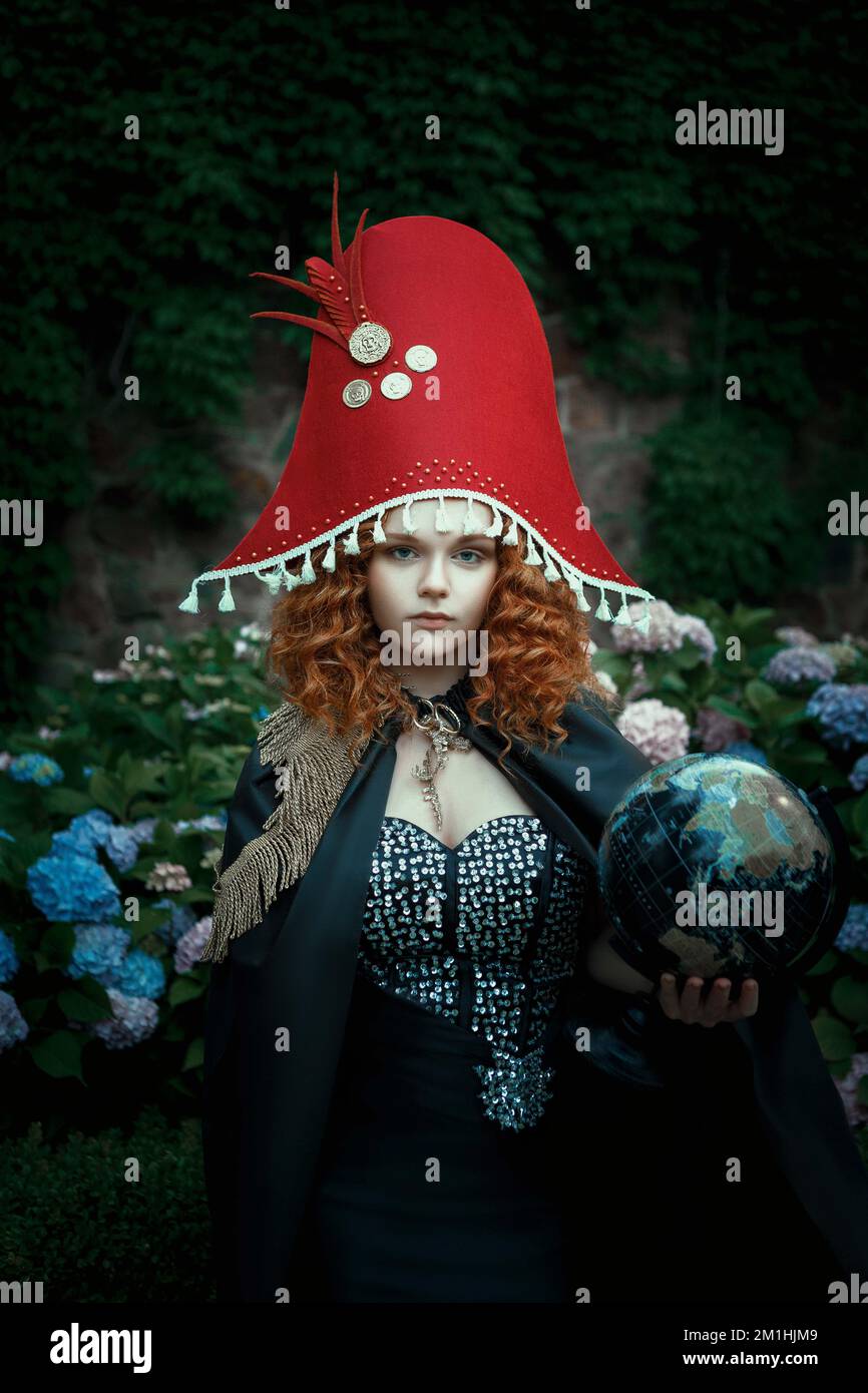 A girl with red curly hair in a creative commander's costume on a dark ...