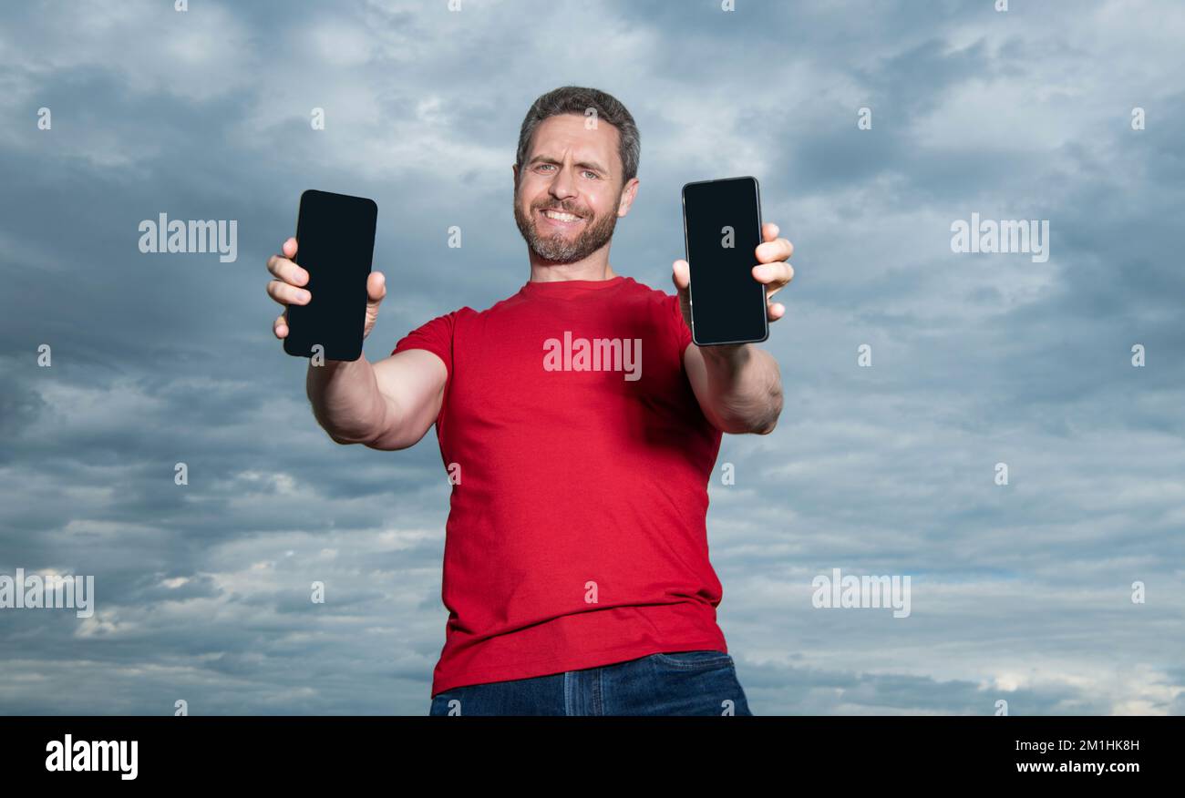 angry man showing phone app wear red tshirt. photo of man showing phone ...