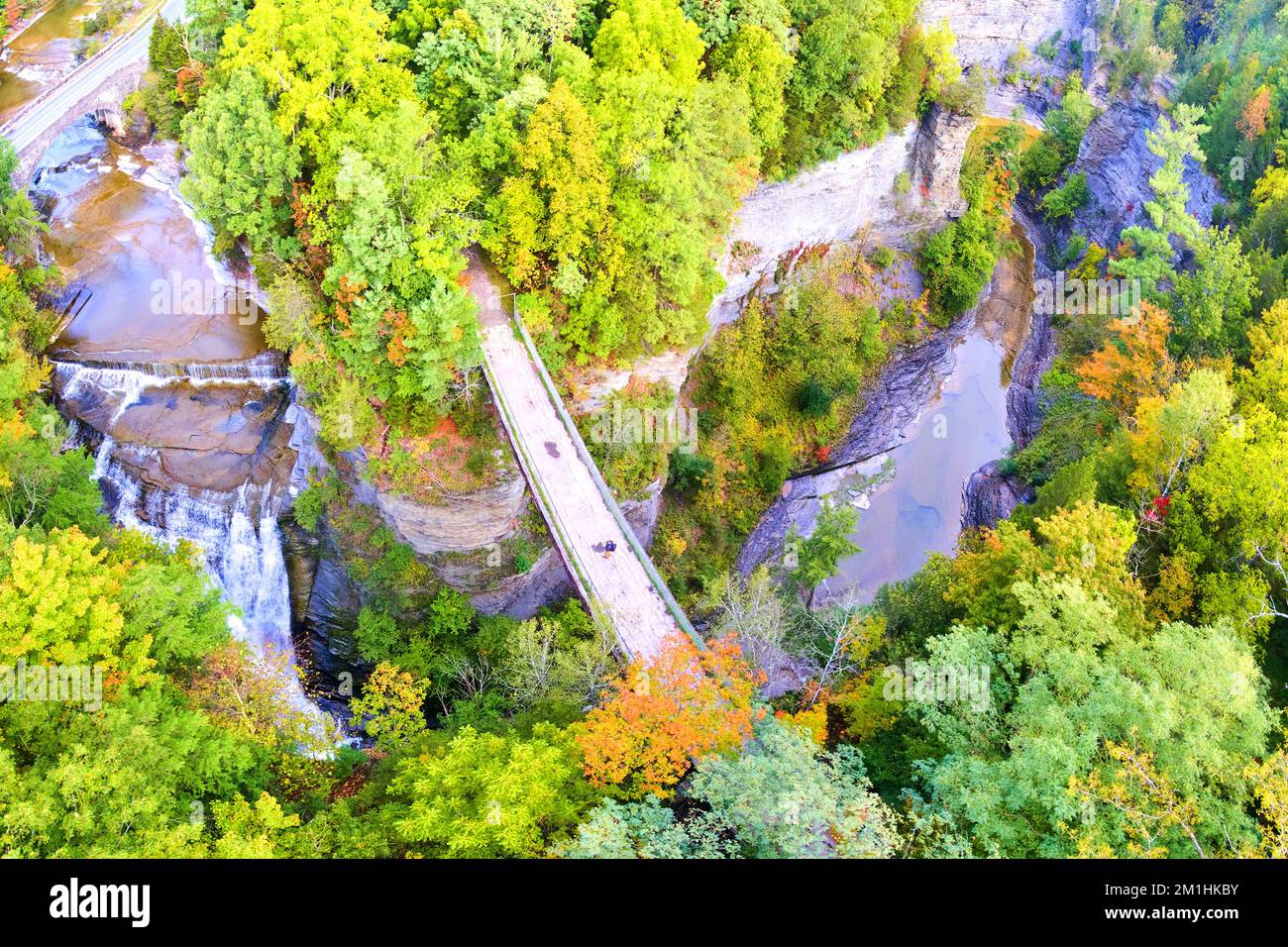 Aerial over large gorge with waterfall and bridges crossing over Stock ...