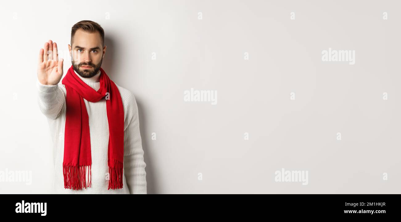 Serious bearded guy saying no, showing stop sign, rejection sign ...