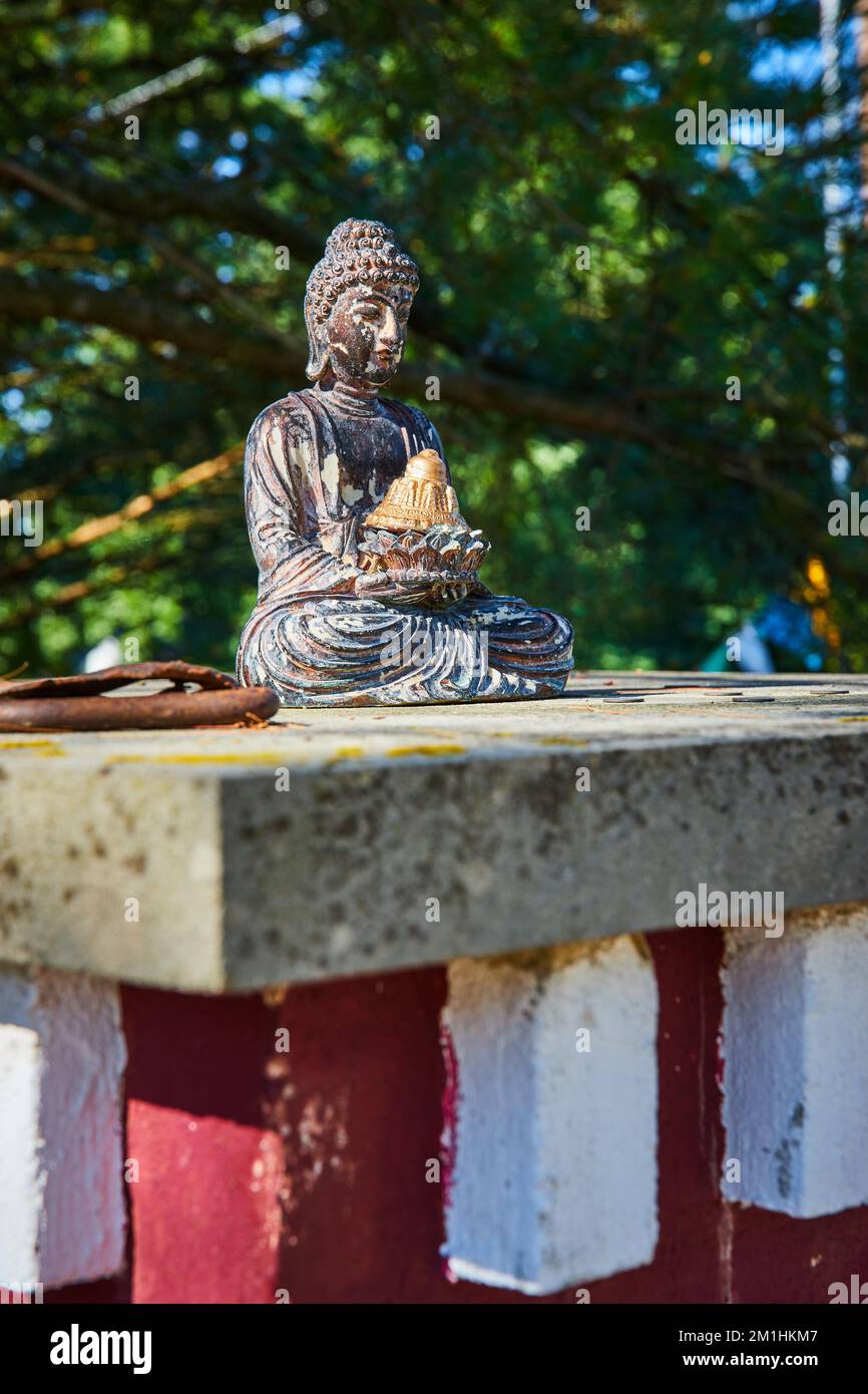 Buddhist statue zen resting on top of cement block Stock Photo - Alamy
