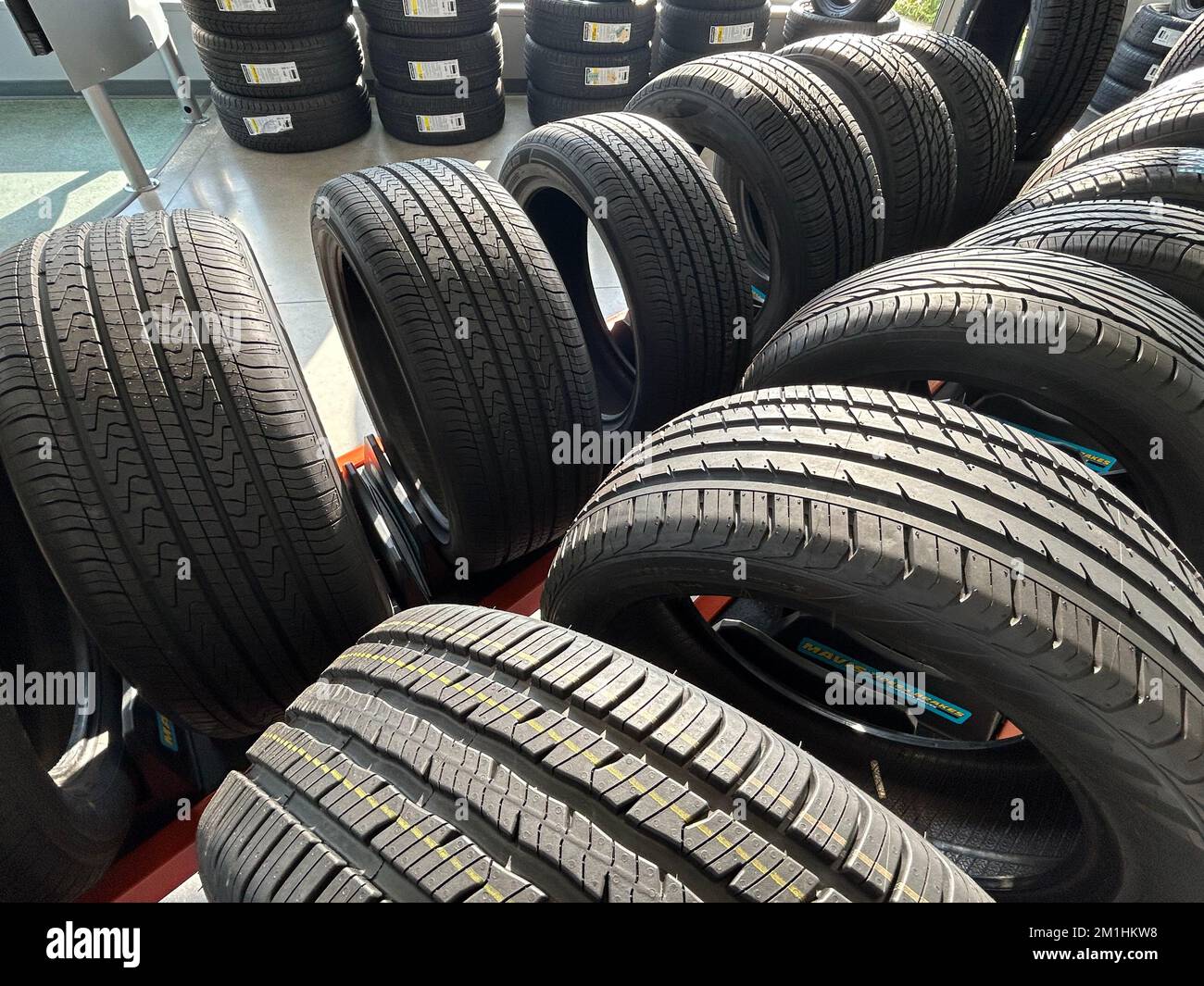 New automobile tires on display at a tire dealership Stock Photo - Alamy