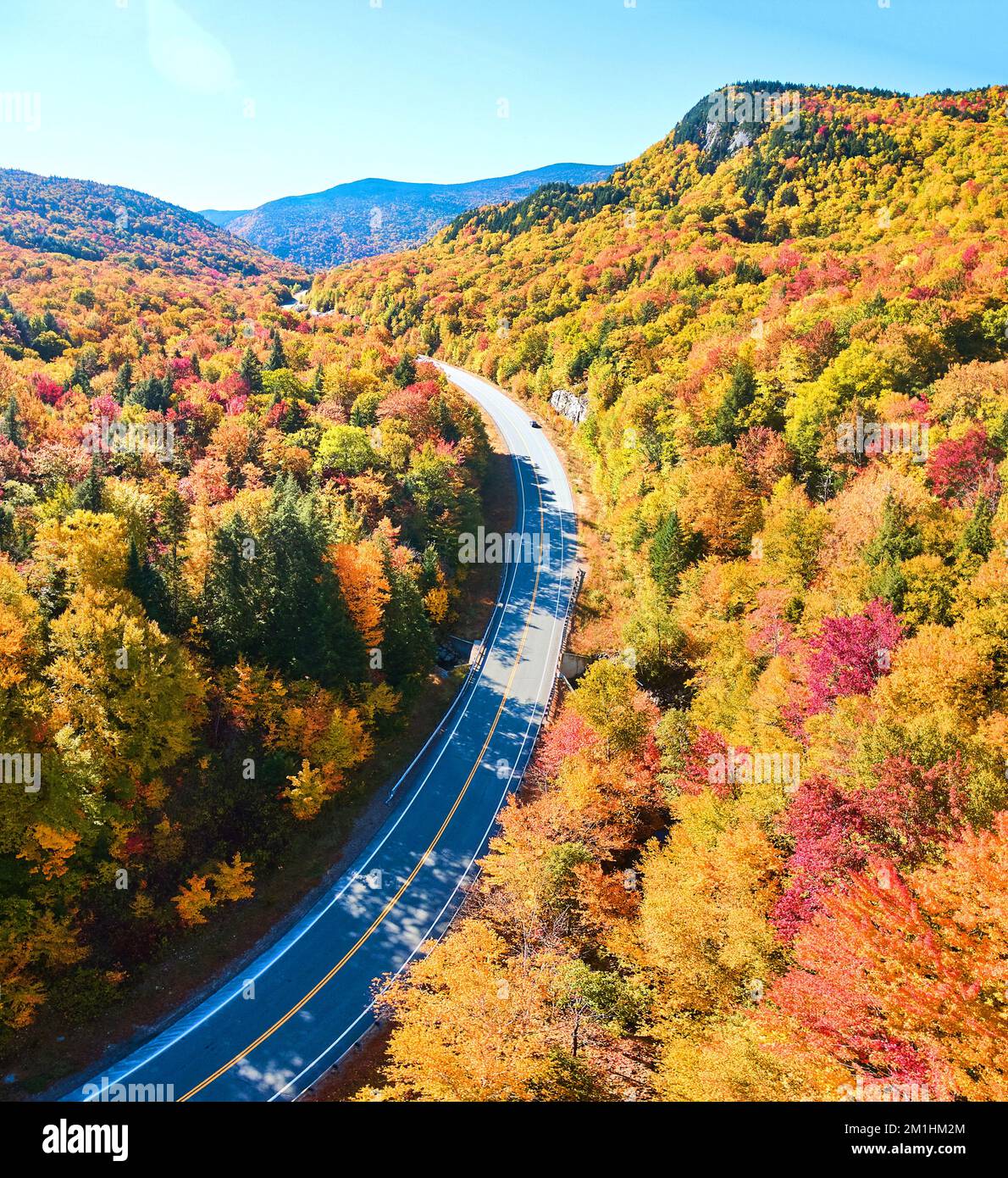 Road winding through New Hampshire mountains in peak fall with stunning ...