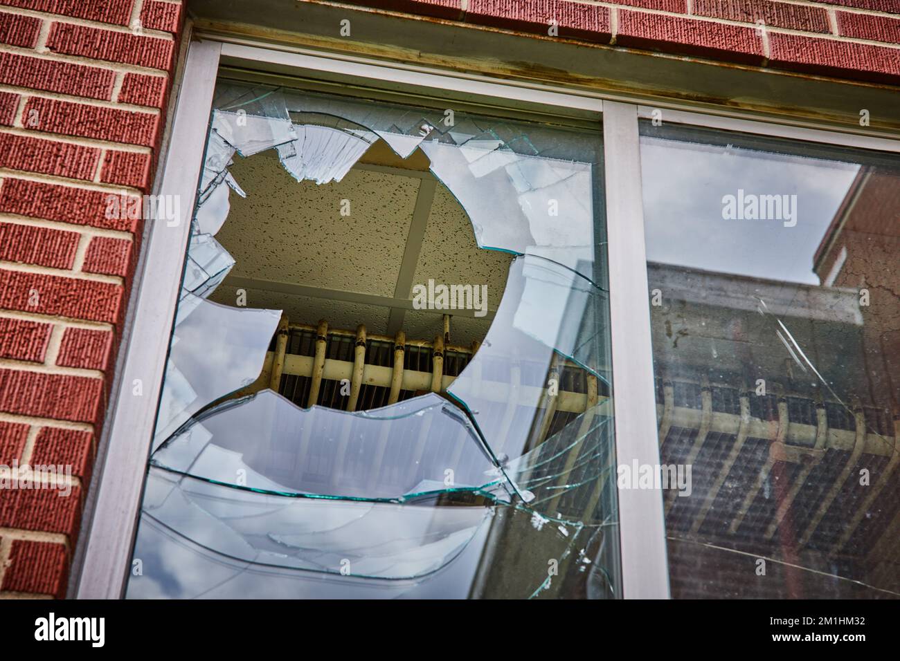 Broken glass window detail with multiple layers on brick building Stock ...