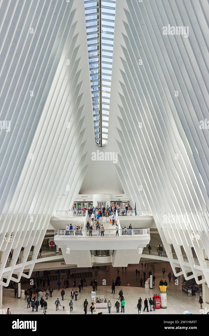 Huge open white and glass subway terminal with light hitting overlook ...