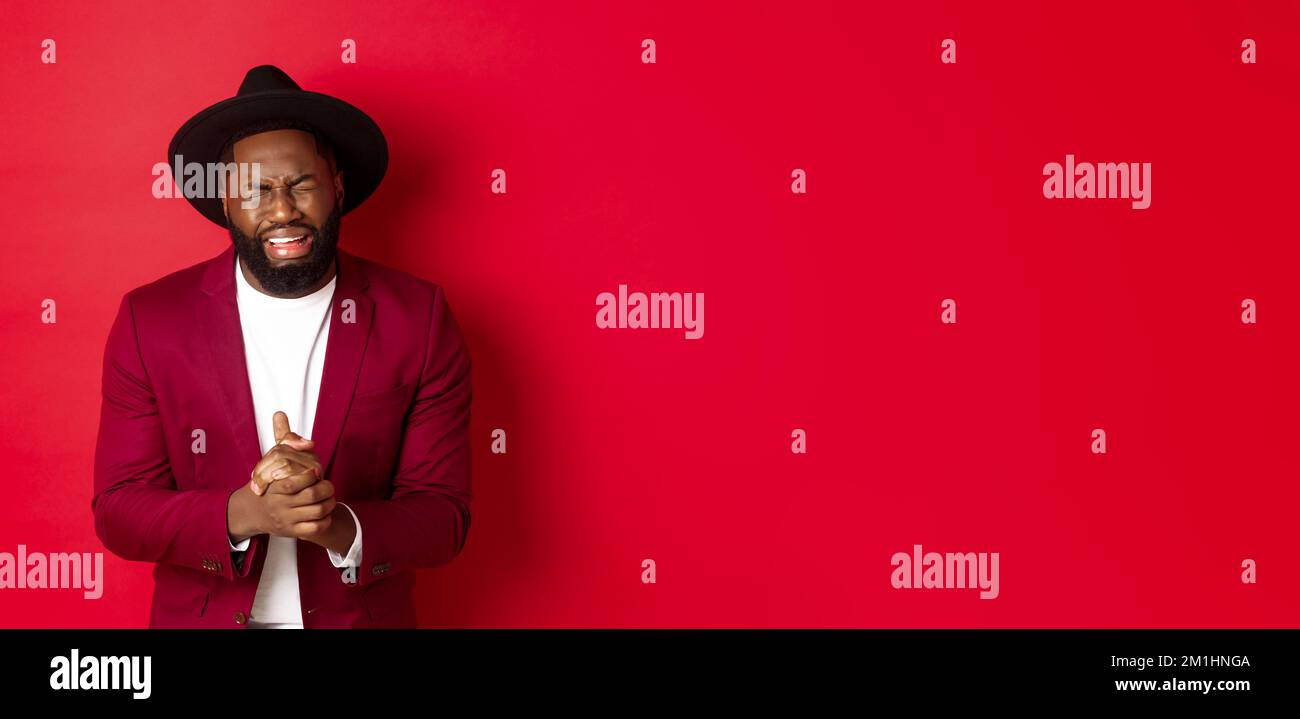 Miserable and heartbroken Black man crying, begging for help, holding ...