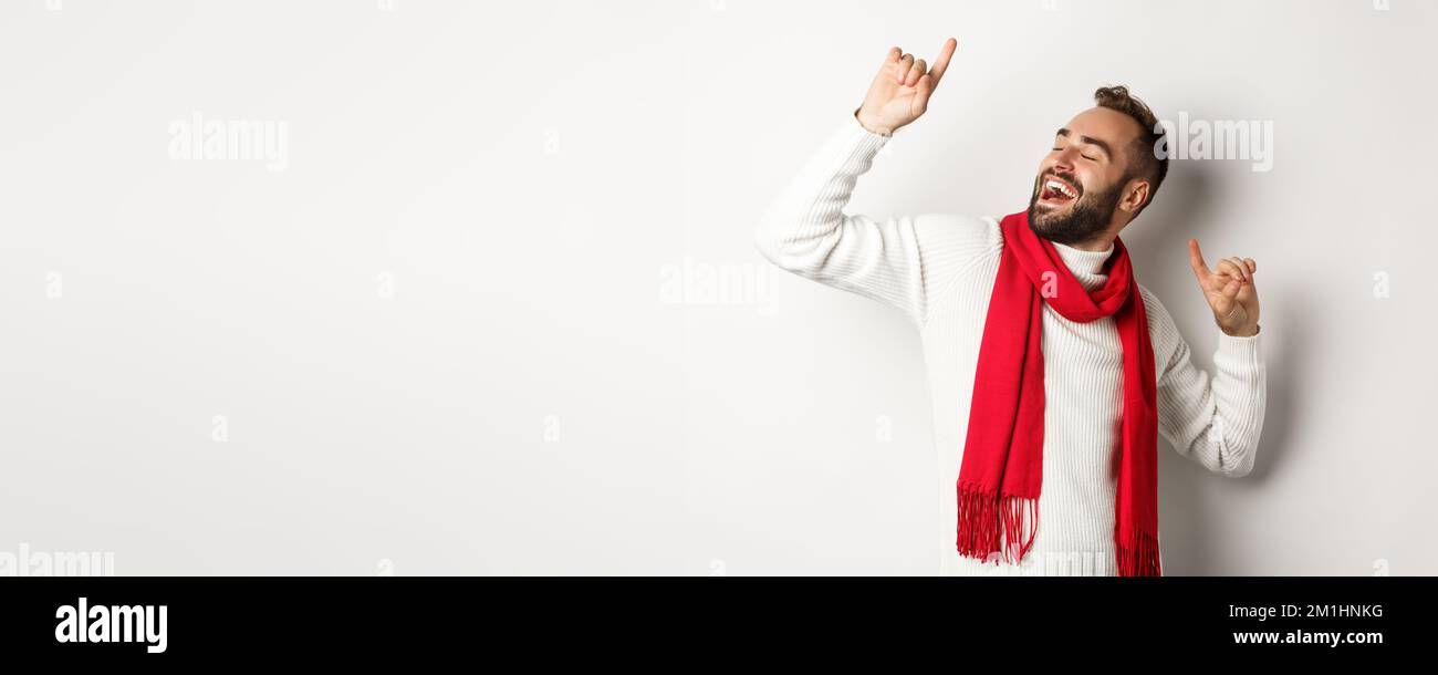 Happy man celebrating christmas party, dancing and pointing fingers ...