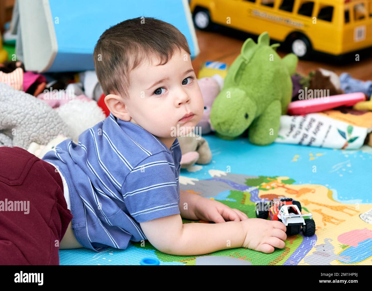 little boy making a slide for his toy cars Stock Photo - Alamy