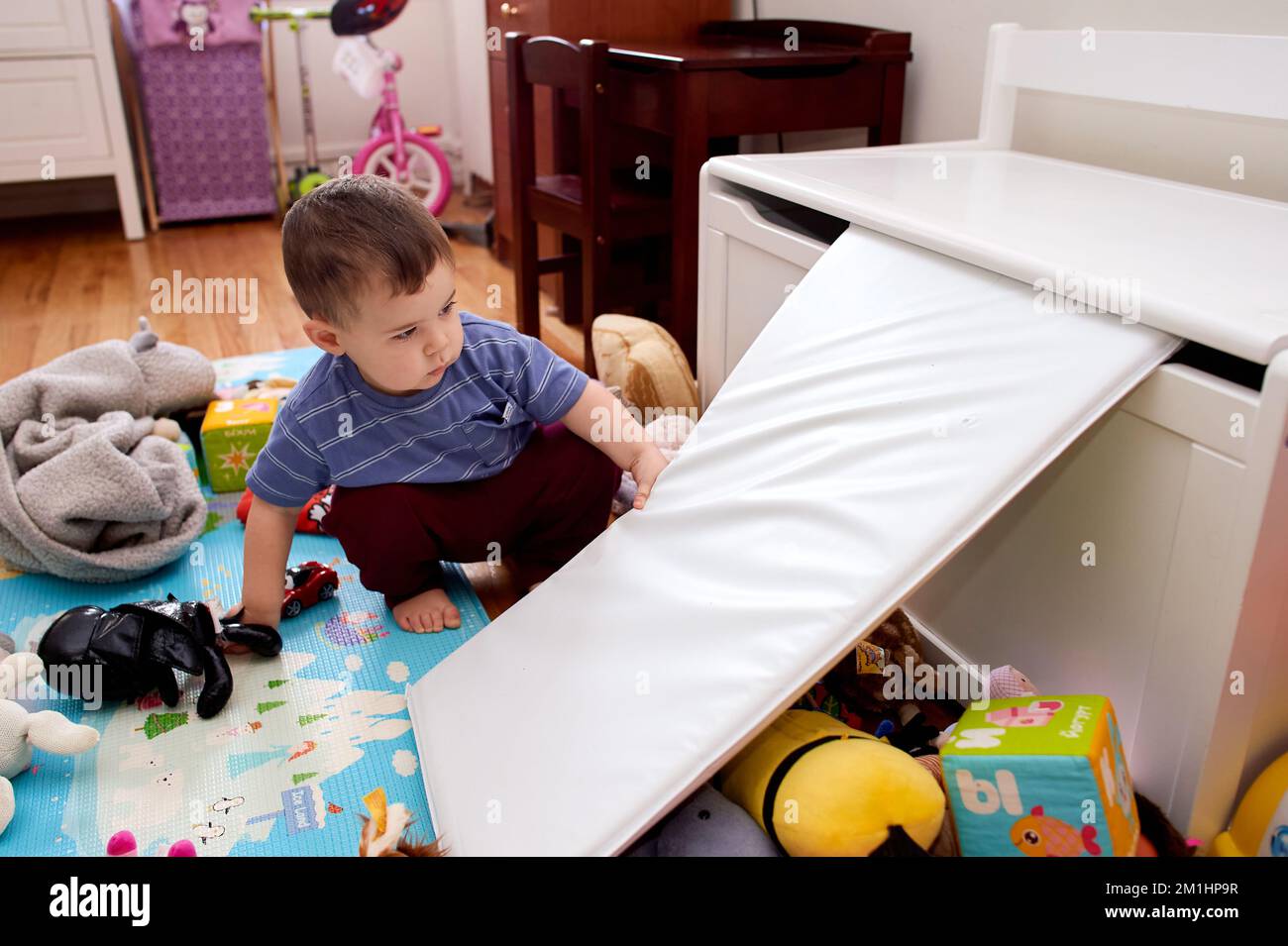 little boy making a slide for his toy cars Stock Photo - Alamy