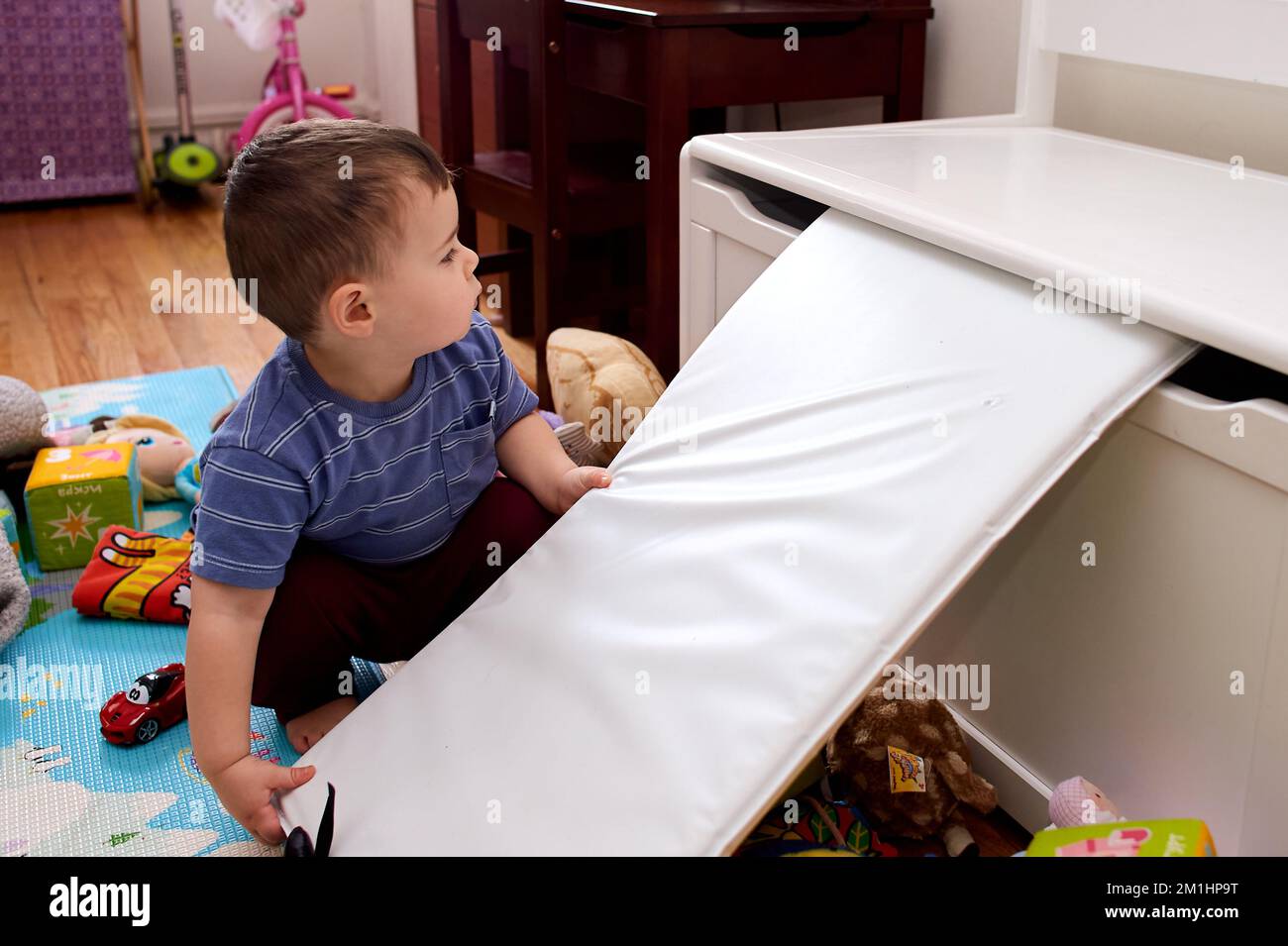 little boy making a slide for his toy cars Stock Photo - Alamy