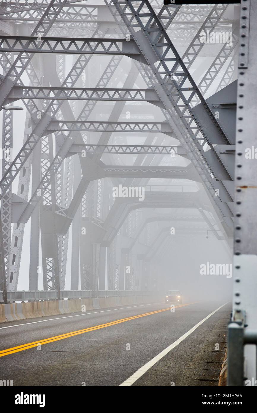 Cars going down extremely foggy steel bridge from side Stock Photo - Alamy
