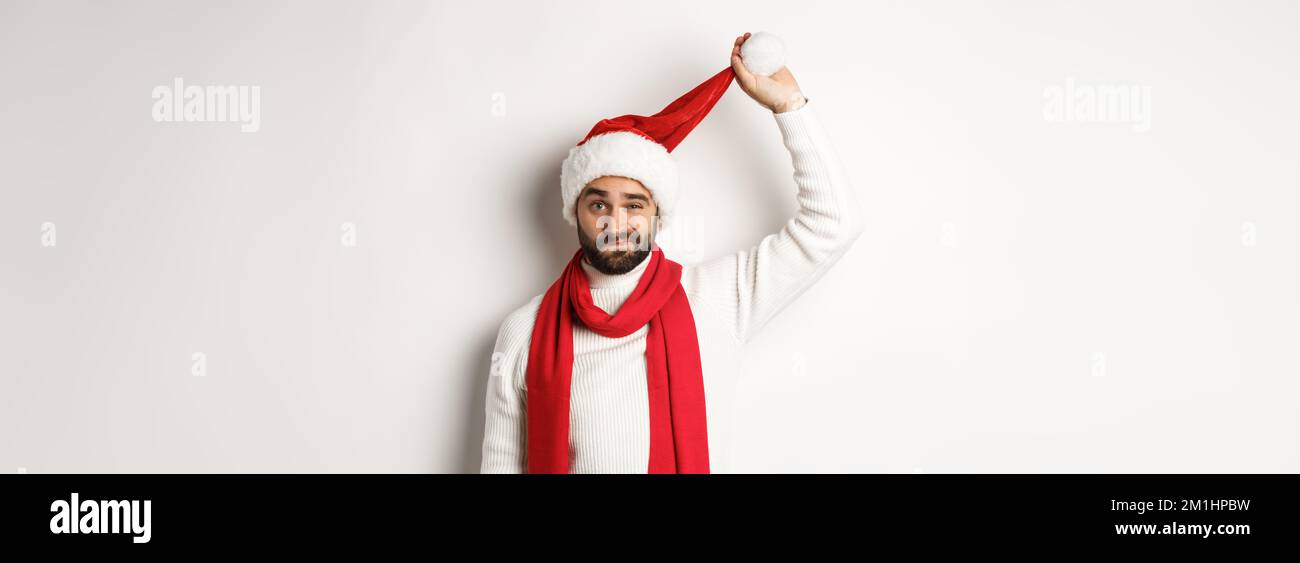 Christmas party and celebration concept. Sad guy taking-off Santa hat ...
