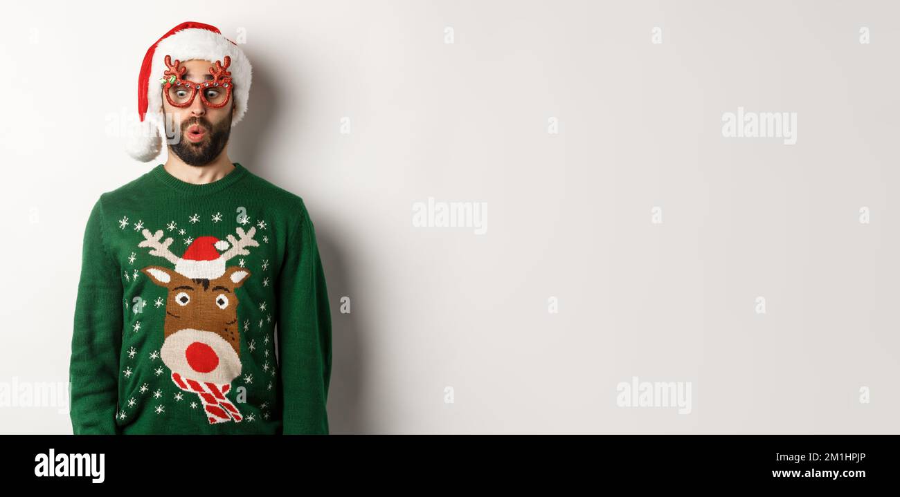 Christmas holidays, celebration concept. Surprised guy in party glasses ...