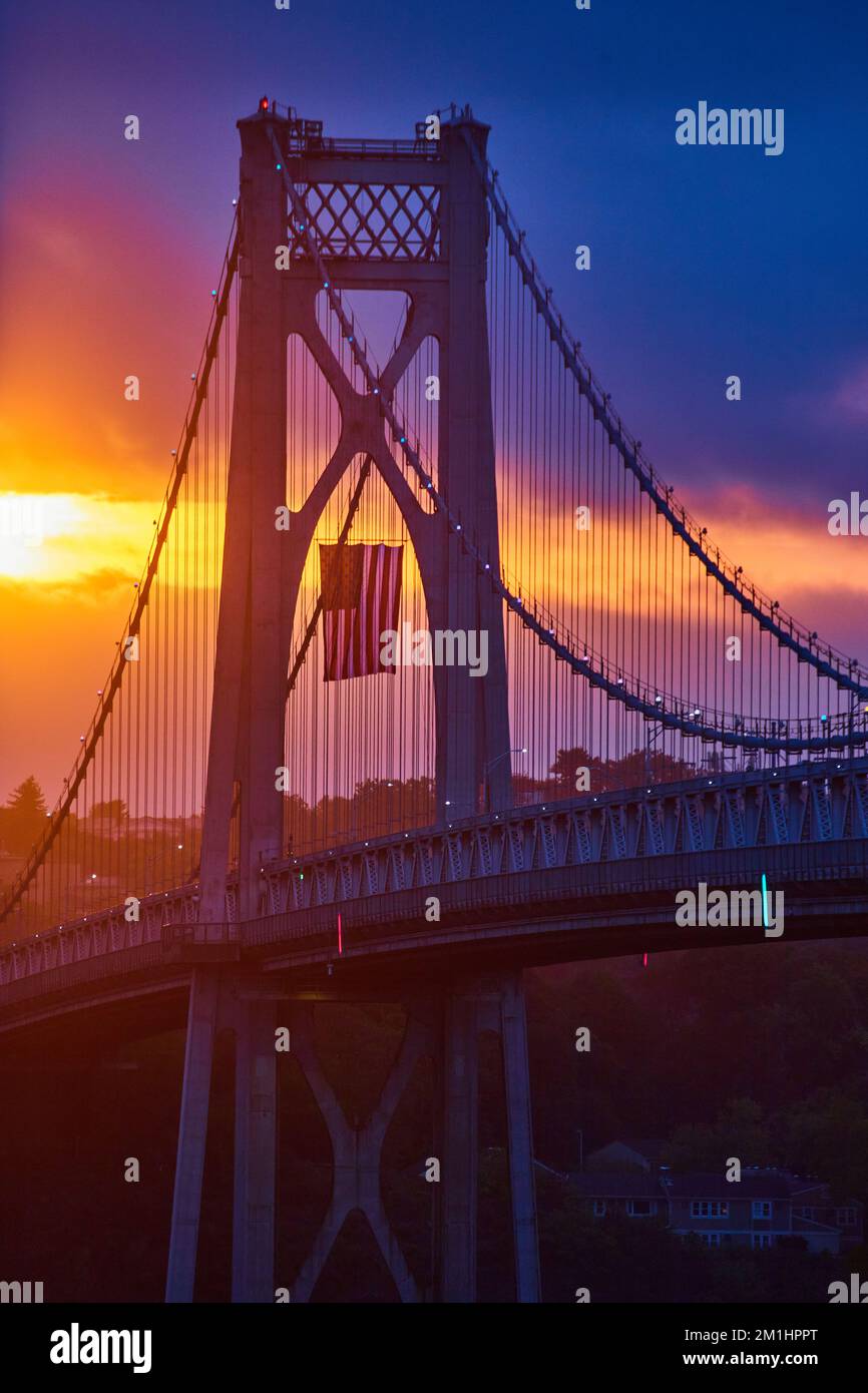 Stunning golden sunrise over American Bridge highlighting American Flag ...
