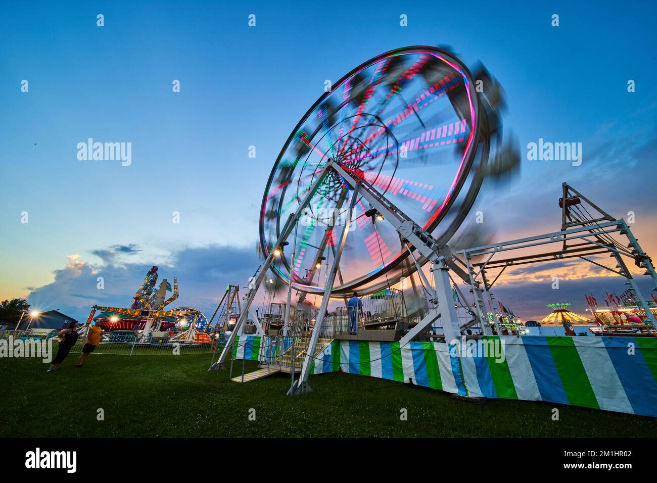 American county fair at dusk with blurred ferris wheel Stock Photo - Alamy