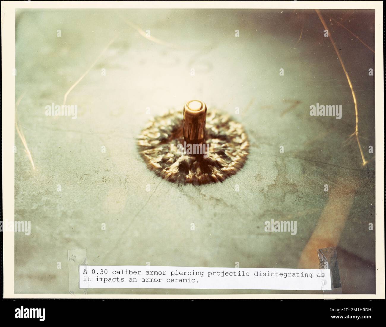 A 0.30 caliber armor piercing projectile disintegrating as it impacts ...