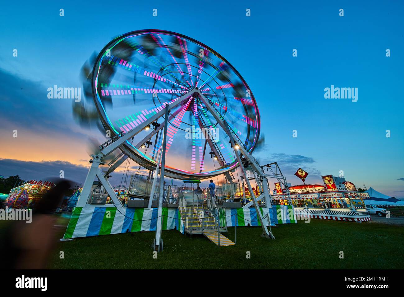 Ferris wheel blurred at carnival county fair in America Stock Photo - Alamy