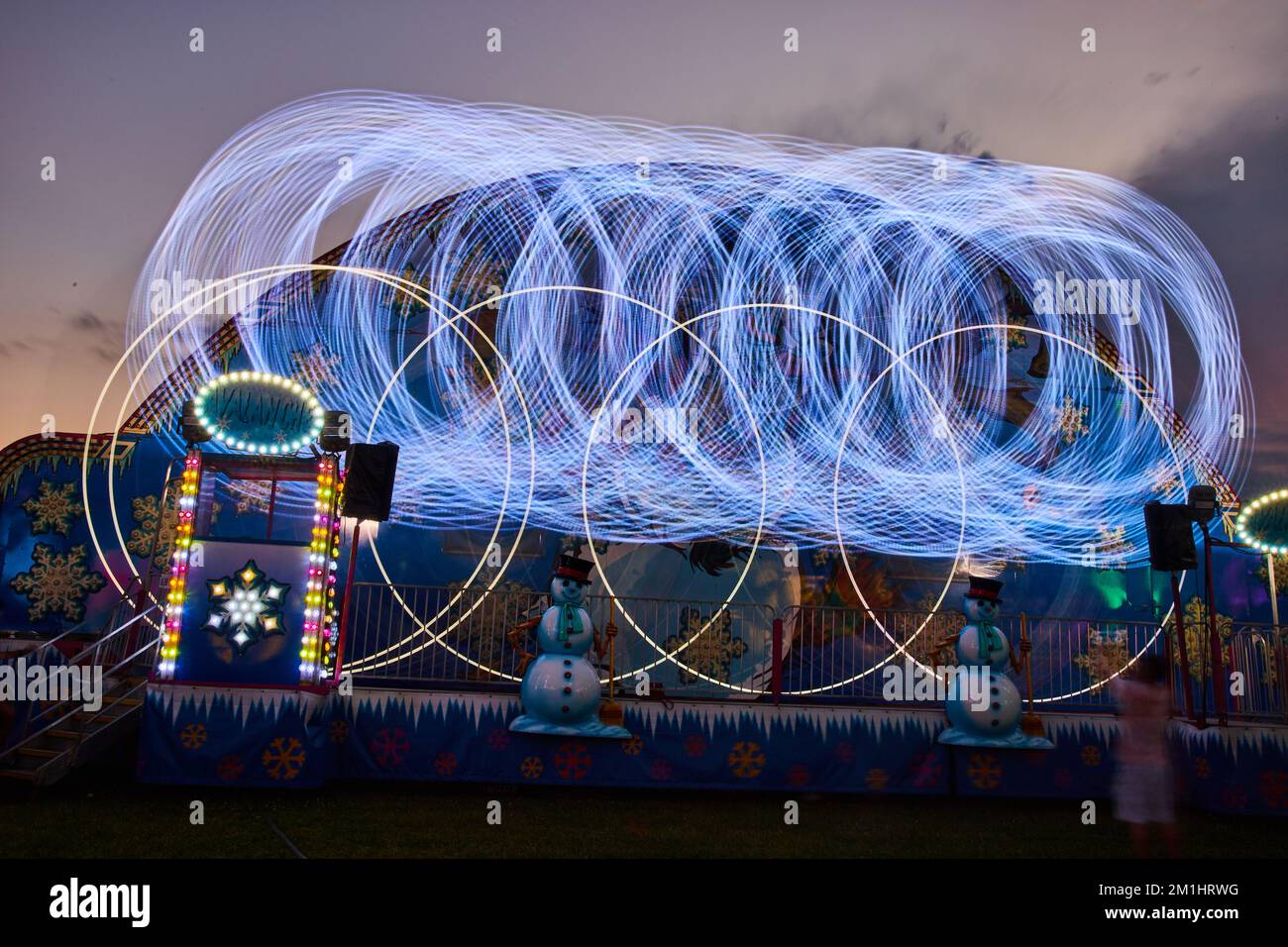 County fair carnival ride with circle light patterns blurred Stock ...
