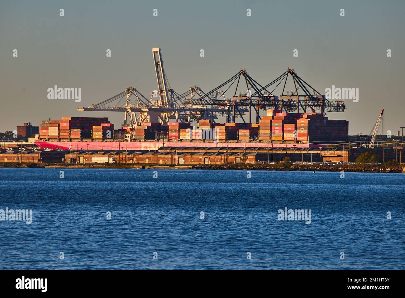 Large ship full of shipping containers loading on coast of New York ...