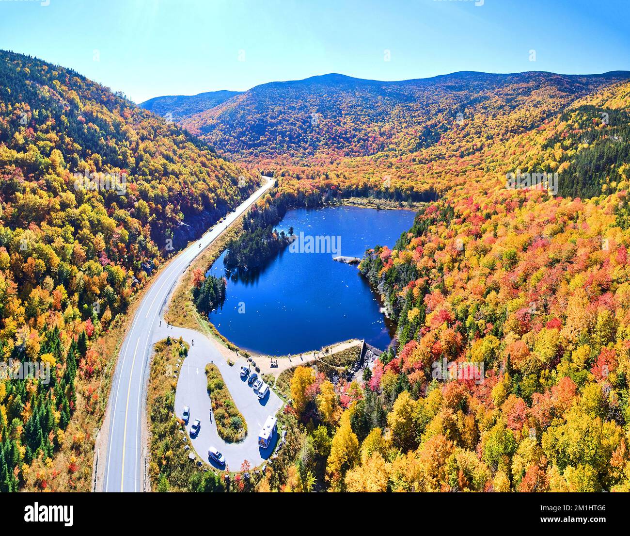 Wide aerial panorama of blue lake and peak fall foliage mountains of ...