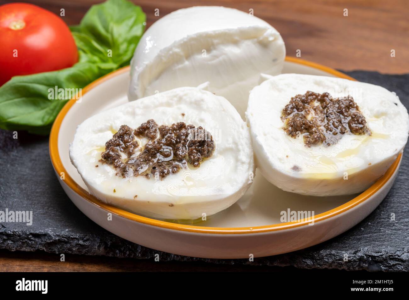 White balls of Italian soft cheese Mozzarella di Bufala Campana stuffed ...